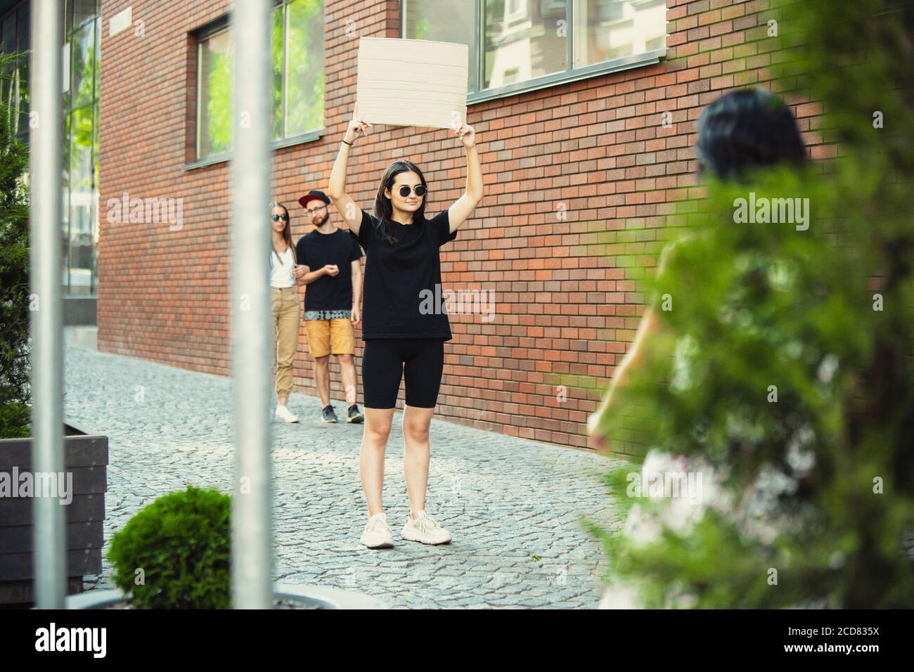 Dude with sign - woman stands protesting things that annoy her. Solo ...