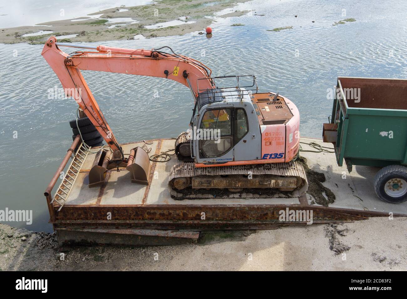 Red mechanical digger on a barge. Leigh on Sea, Essex Stock Photo - Alamy
