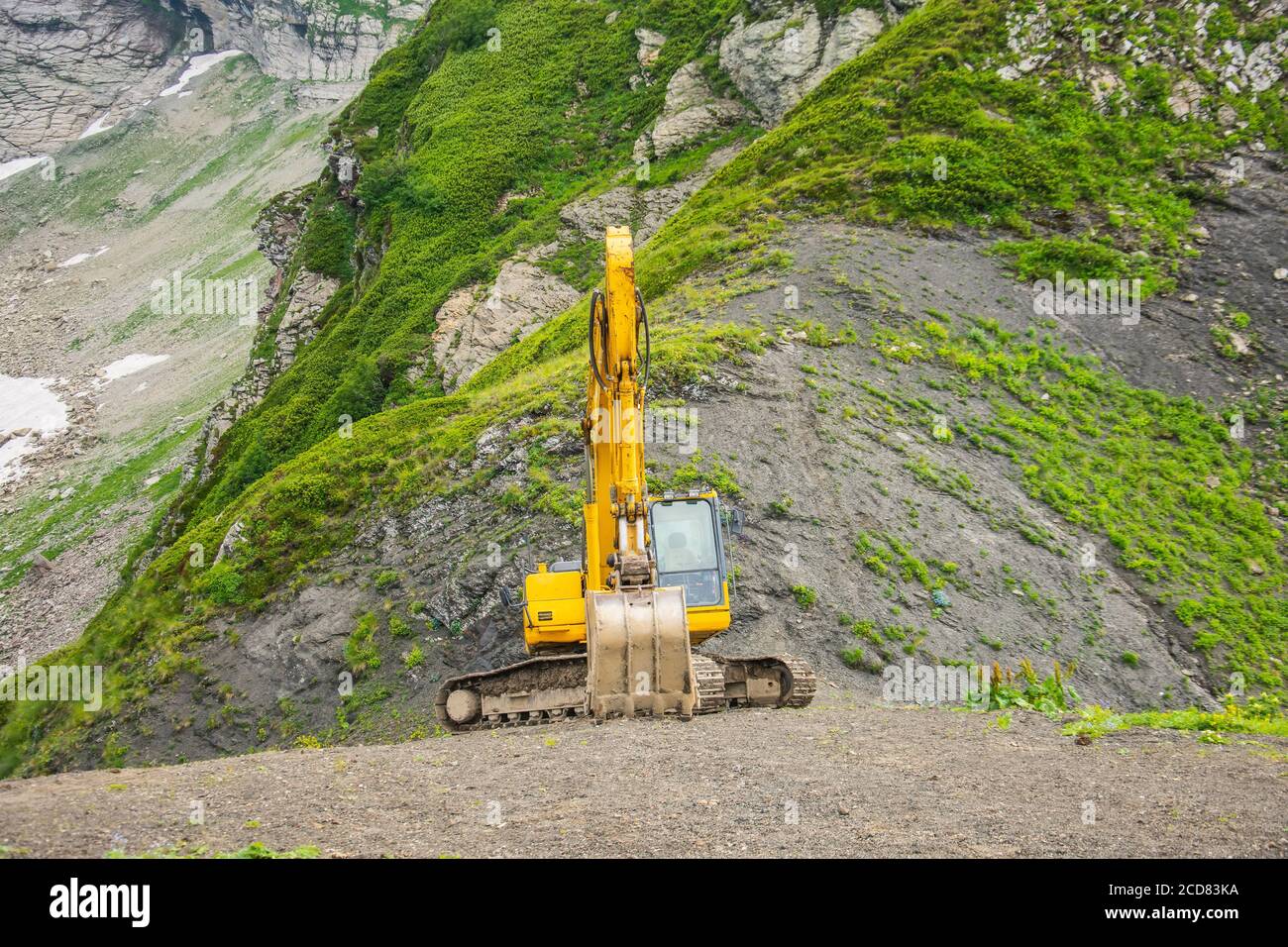 Excavator heavy equipment in mountains on steep range slopes Stock ...