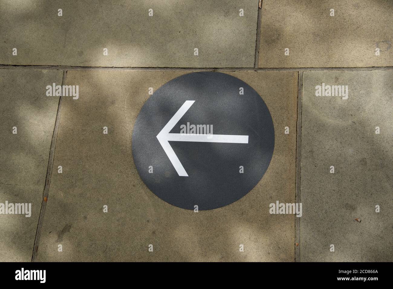 Direction of pedestrian walking sign on the pavement of a London street ...