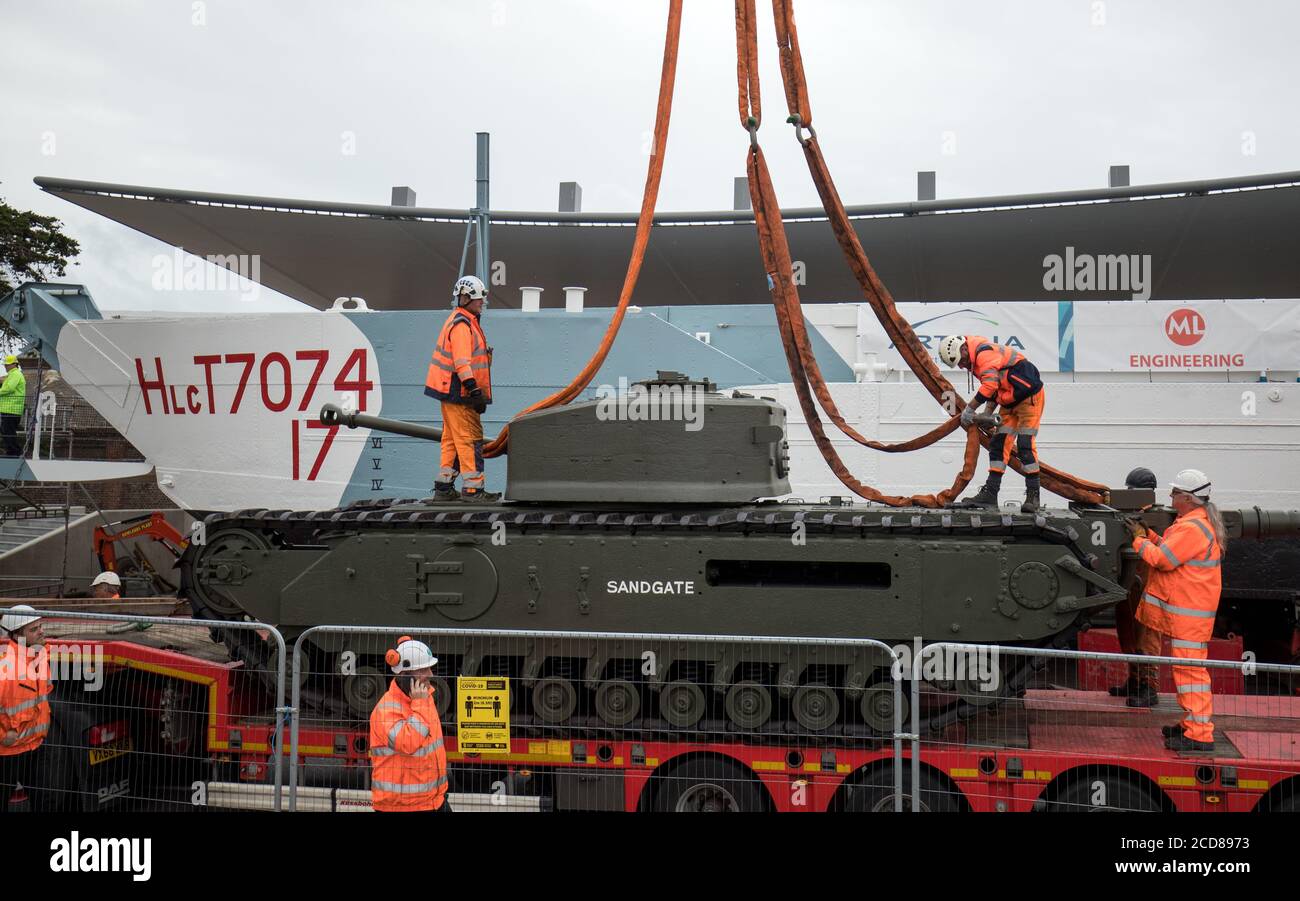 A Churchill Crocodile tank is readied to be craned onto the restored ...