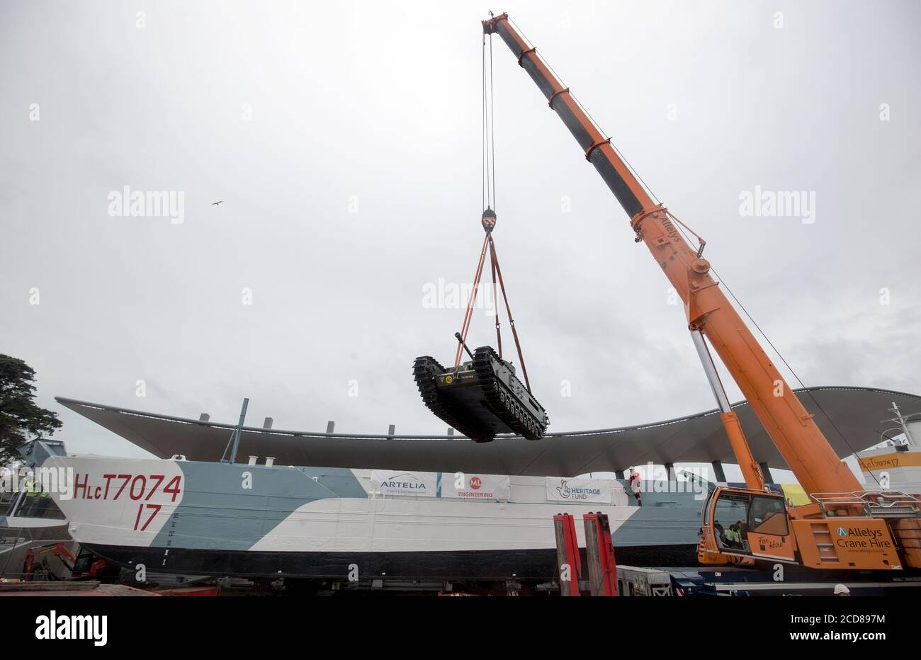 A Churchill Crocodile tank is craned onto the restored World War Two ...