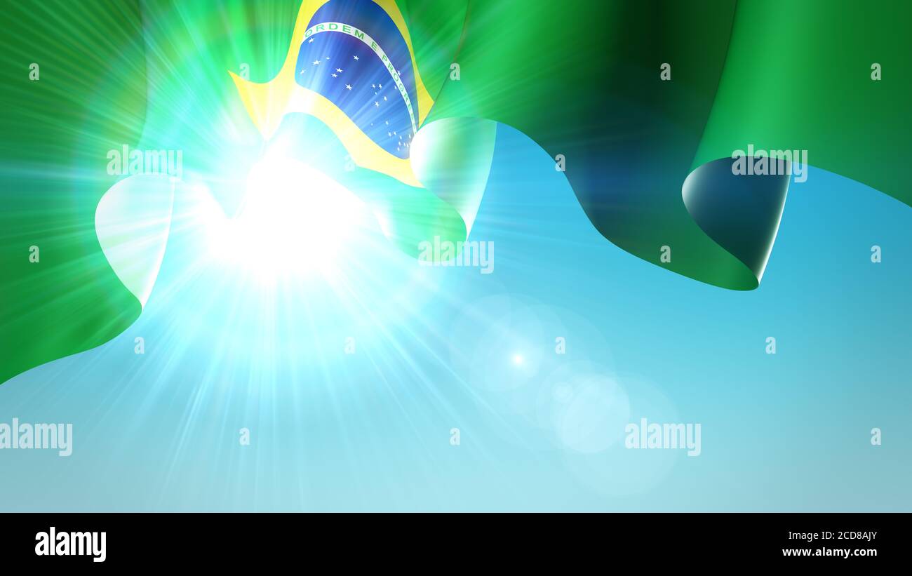 The sun shines with golden rays through the waving flag of brazil ...