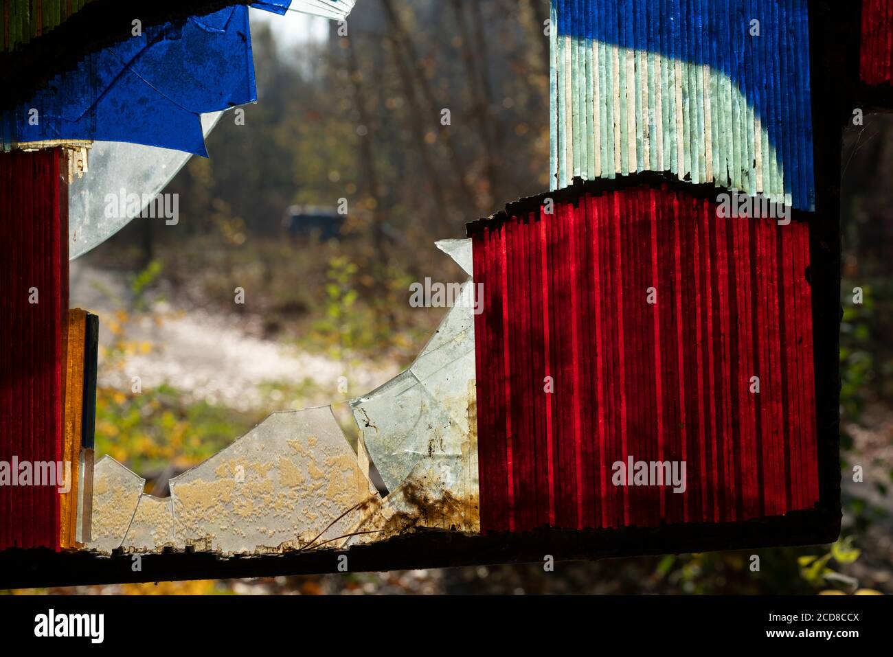Fragment of colored bright stained-glass windows with red and blue ...