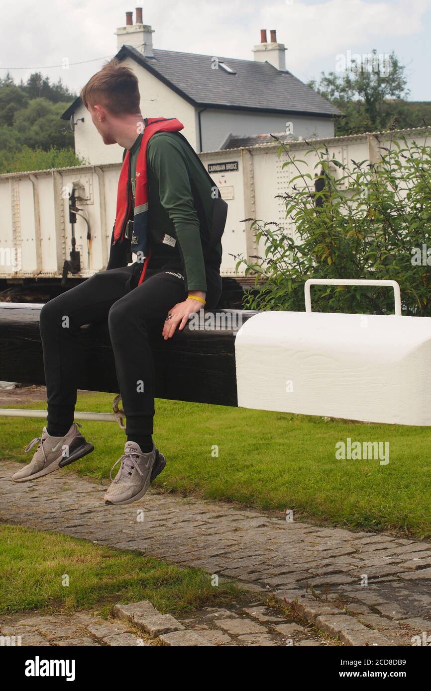 A view of a young man in charge of operating the balance beam at lock ...