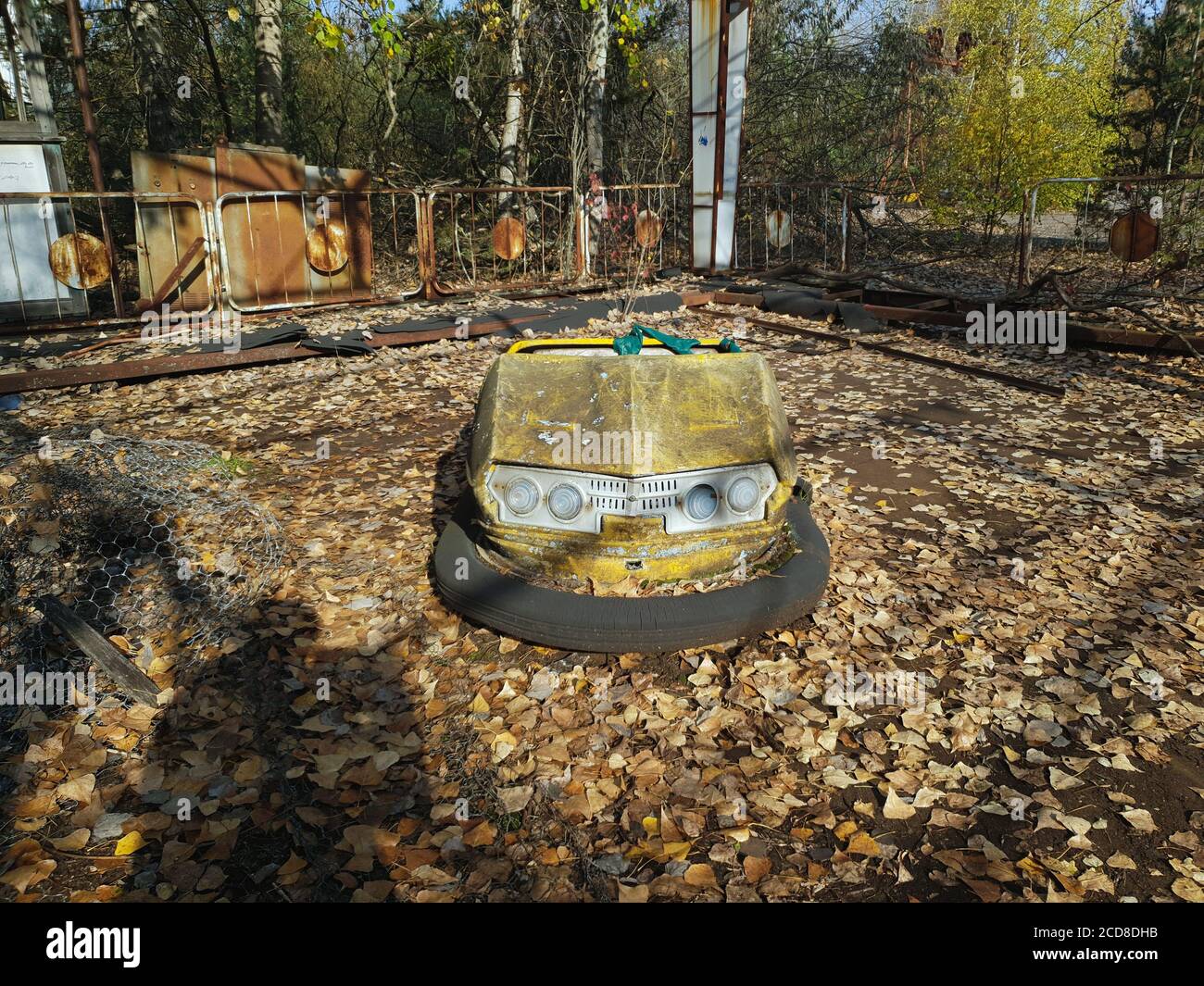 Old broken rusty metal radioactive yellow cars, children leave an ...