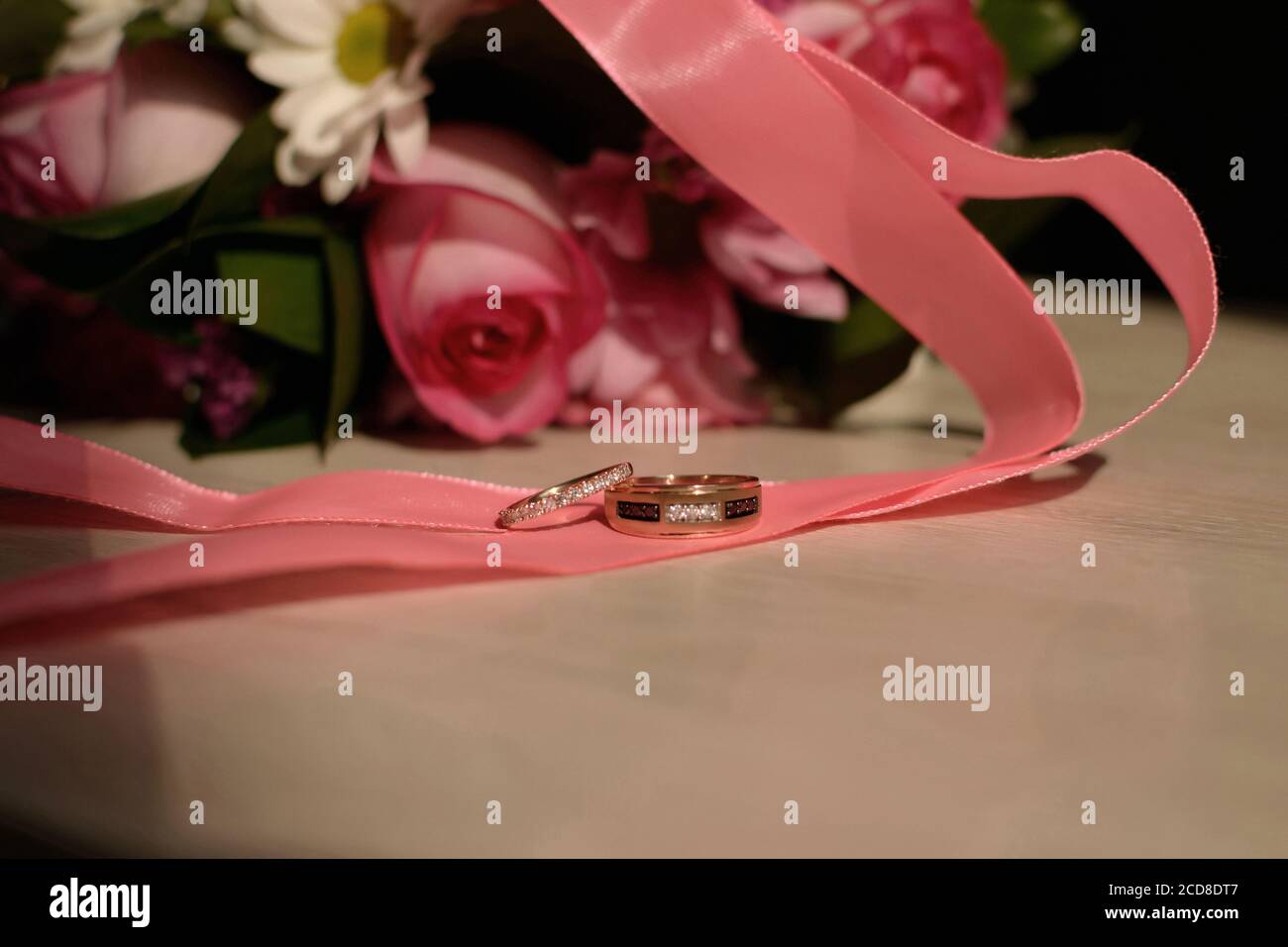 Gold wedding rings red ribbon hi-res stock photography and images - Alamy