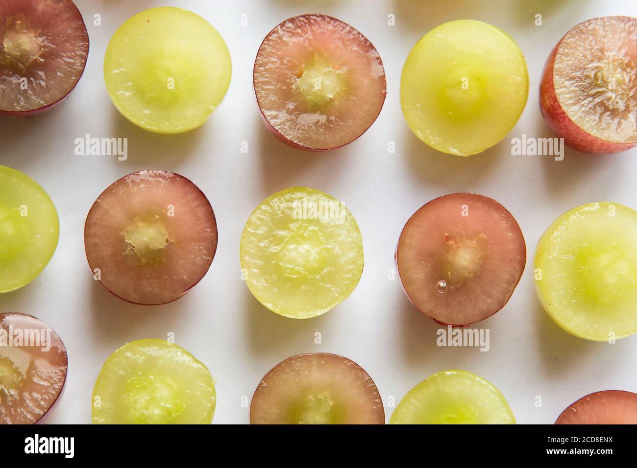 Dissected grapes in rows on a white background Stock Photo - Alamy