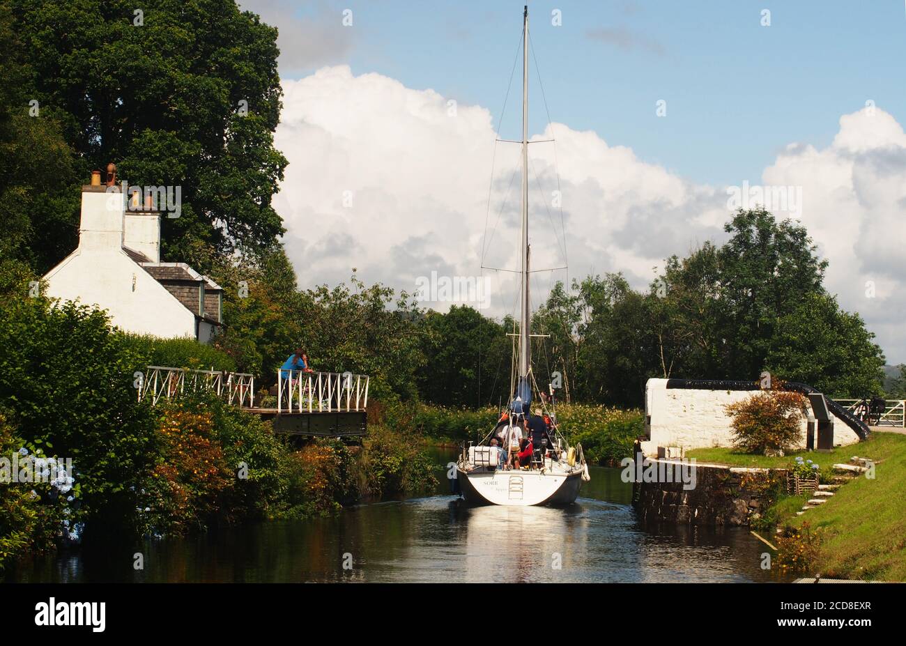 A yacht on the Crinan Canal just passing through the Crinan swing ...