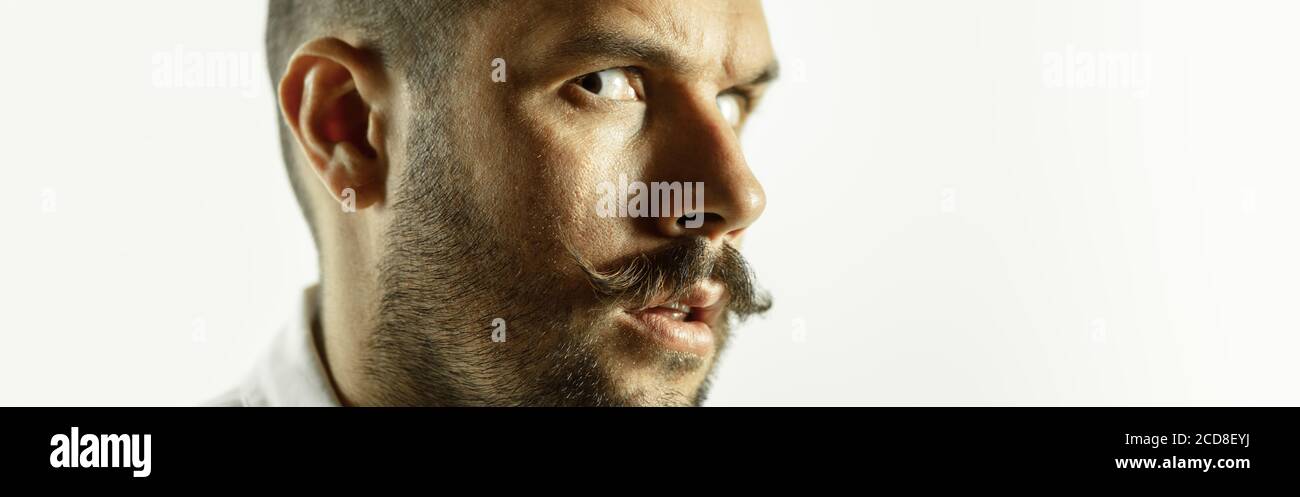 Asking. Caucasian young man's close up cropped shot on studio ...