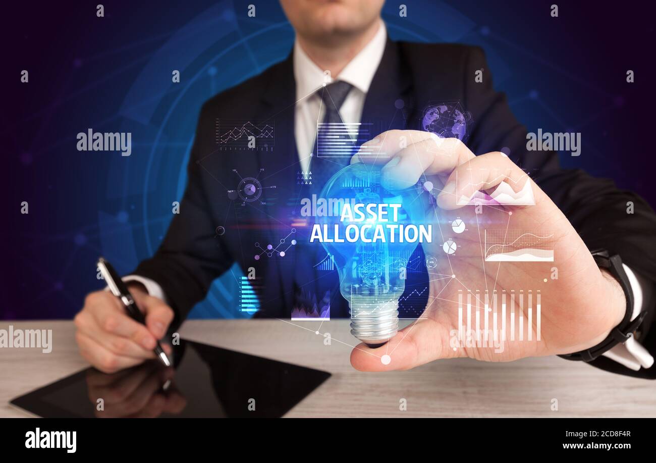 Businessman holding lightbulb with ASSET ALLOCATION inscription ...