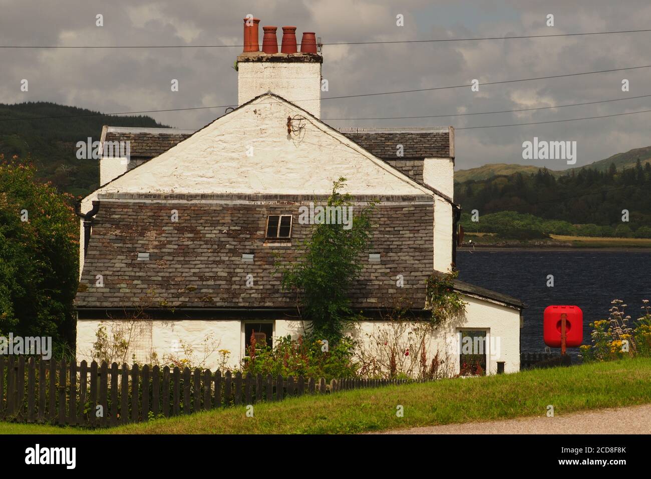 A traditional house set between the end of the Crinan Canal at Crinan ...
