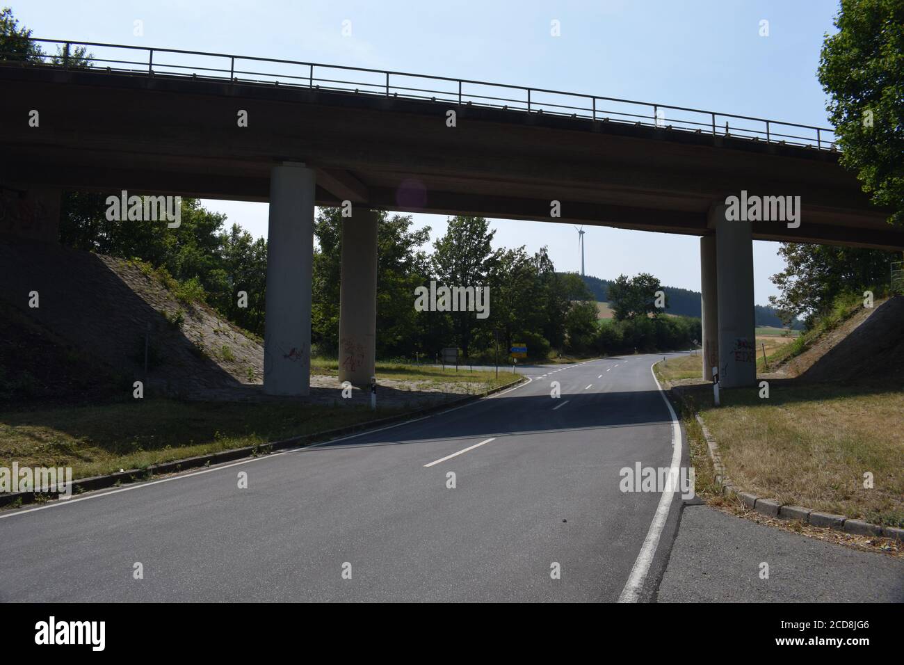 intersection with main road and small country road under the bridge ...