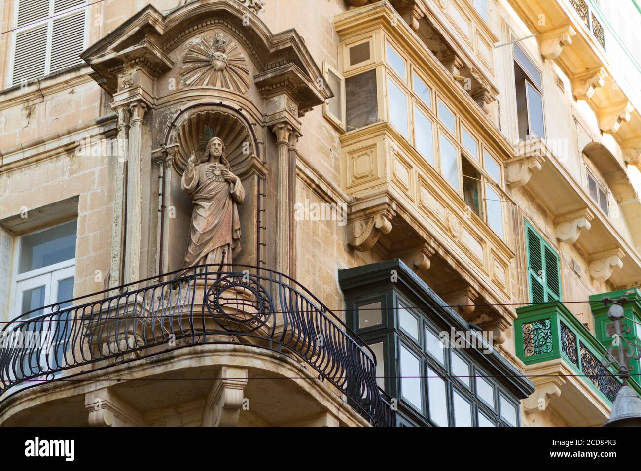 A statue of Jesus on a building corner in Valletta, Malta Stock Photo ...