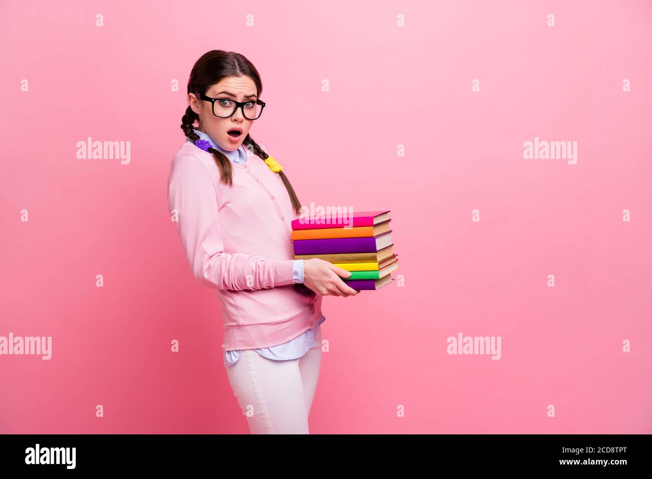 Profile photo of pretty shocked student lady hold heavy books pile ...