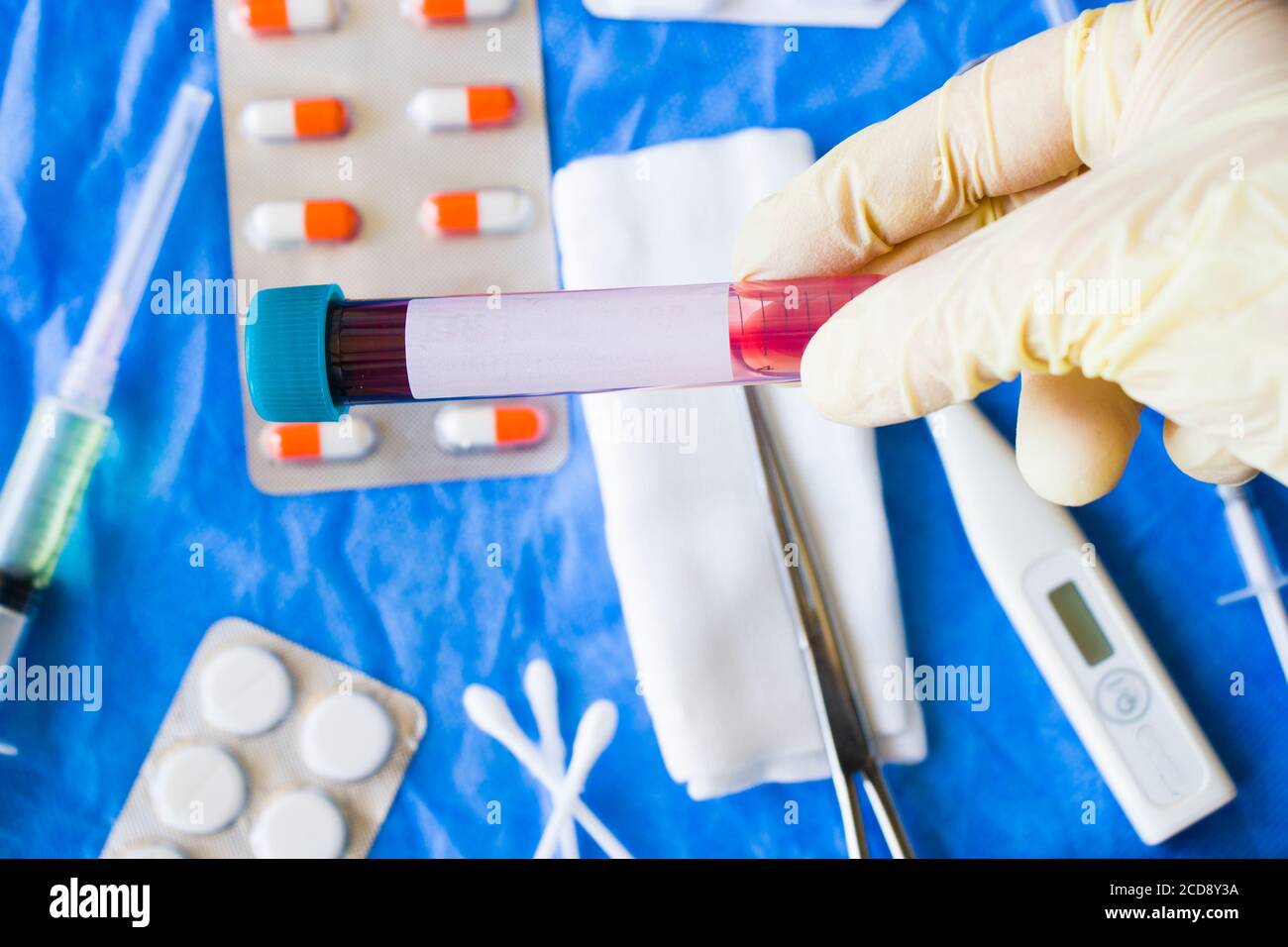 Blood test tube simple in hand with glove, drugs and thermometer Stock ...