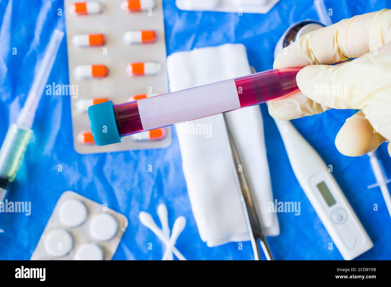 Blood test tube simple in hand with glove, drugs and thermometer Stock ...