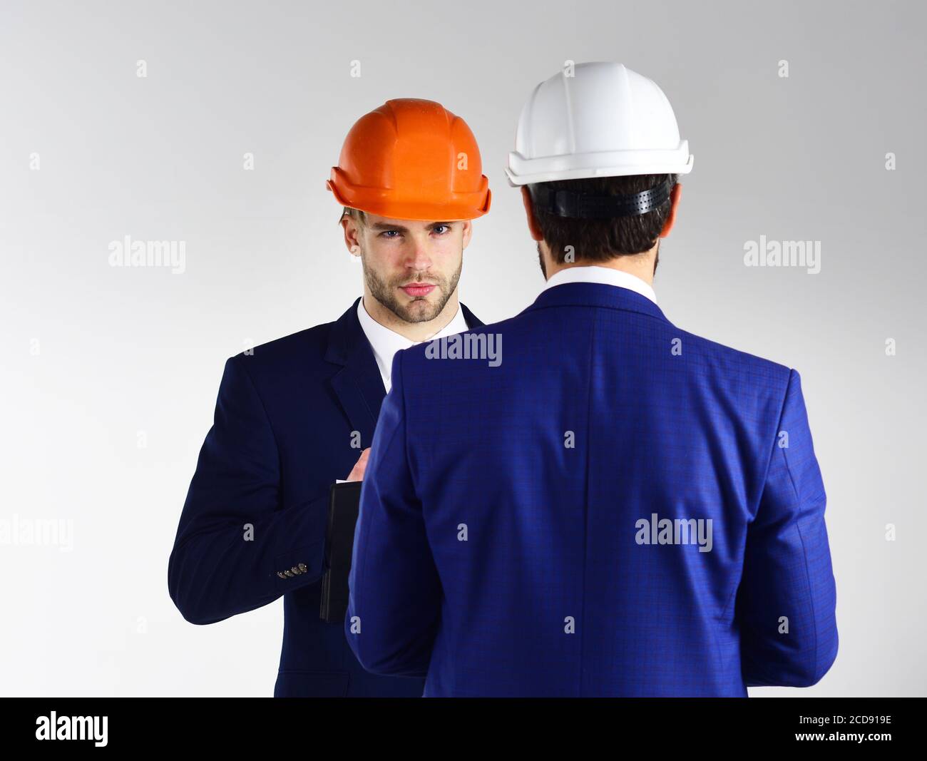 Construction, business people, design concept. Engineers with serious ...