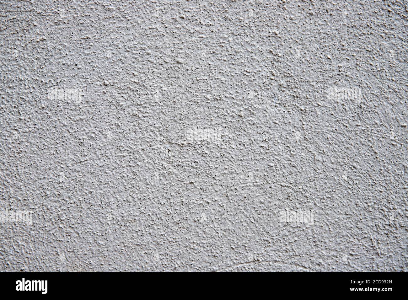 White plaster painted wall with grain and noise. Cracked wall closeup ...
