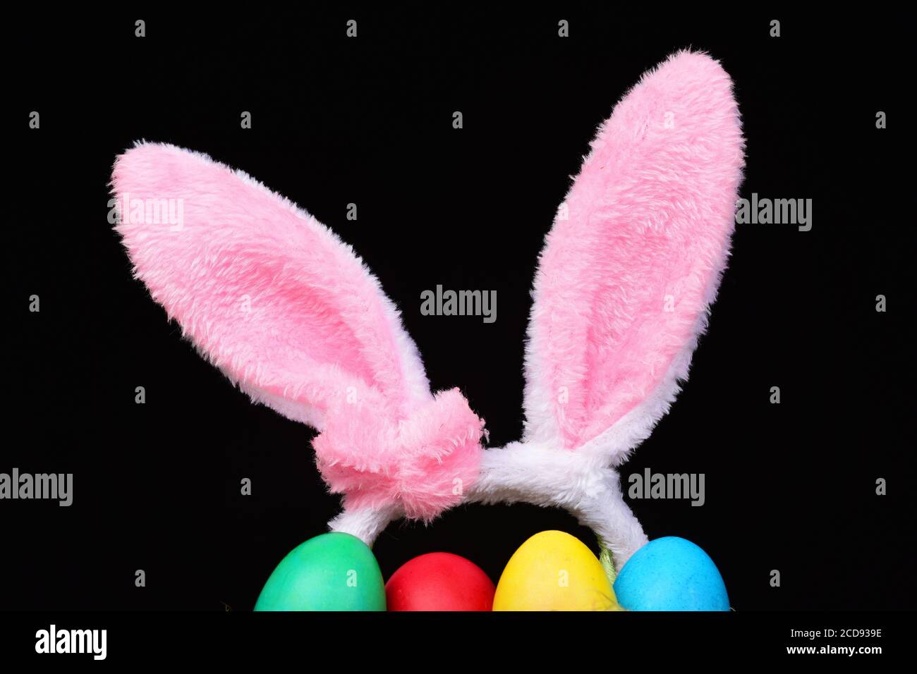 Easter symbols concept. Fluffy rabbit ears with colorful painted eggs ...