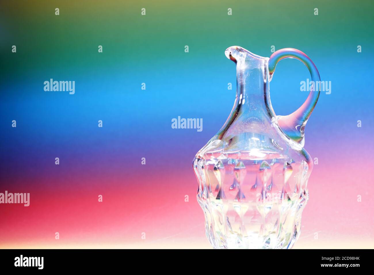 Glass jug on a colorful background Stock Photo - Alamy