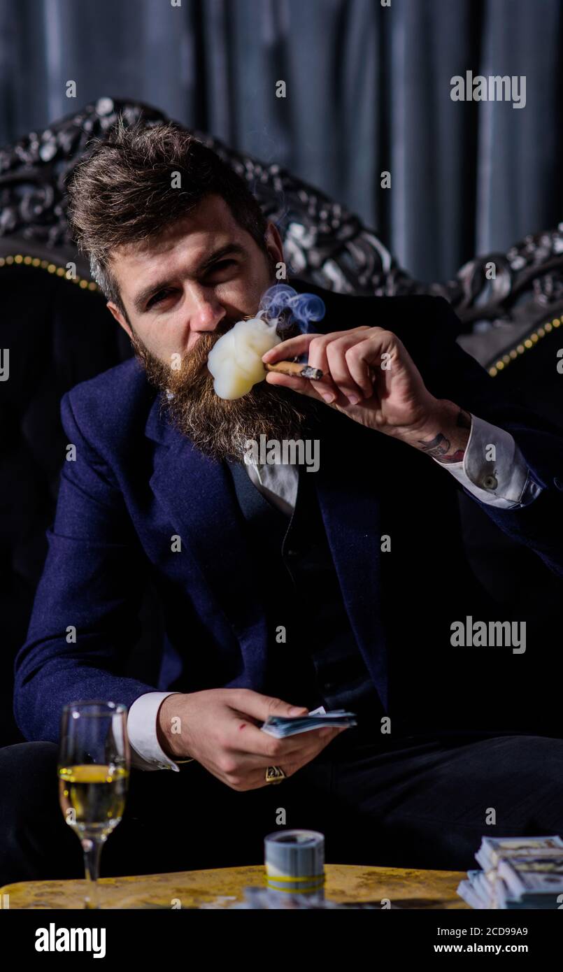 smoking gangster holding dollar bills in vintage luxury room Stock ...