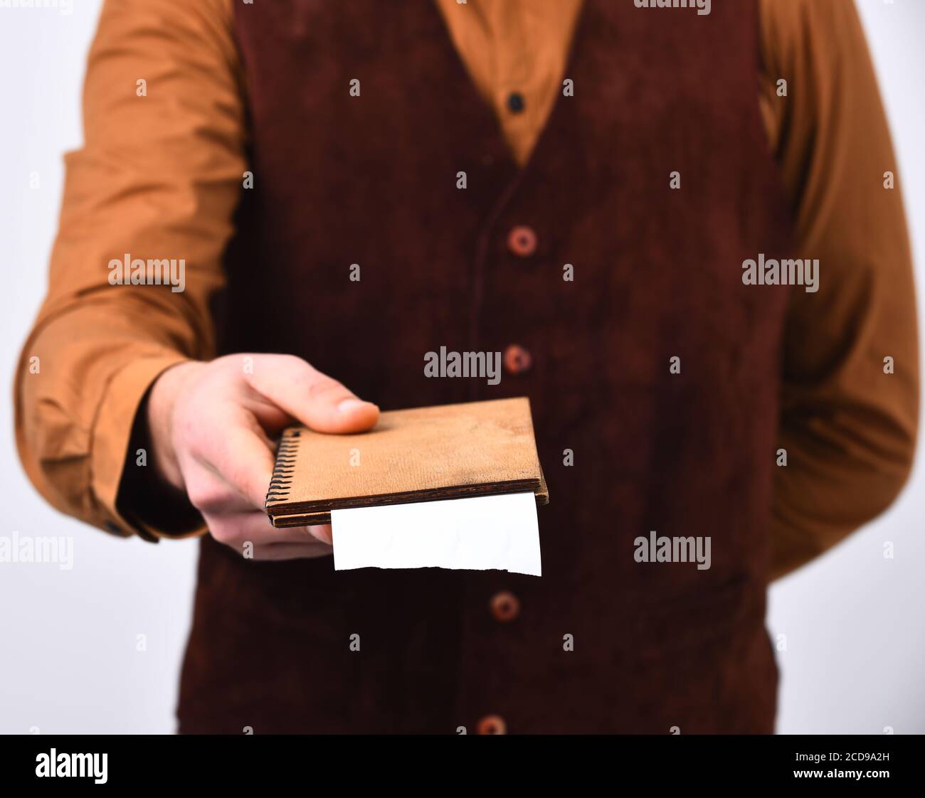 Male servant holds bill on white background. Waiter gives check book ...