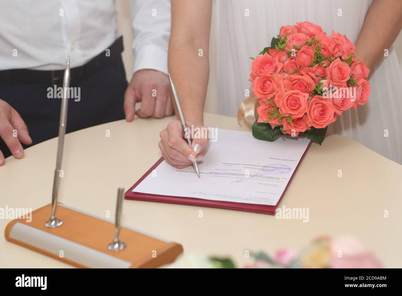 The bride and groom sign the marriage contract after the wedding ...