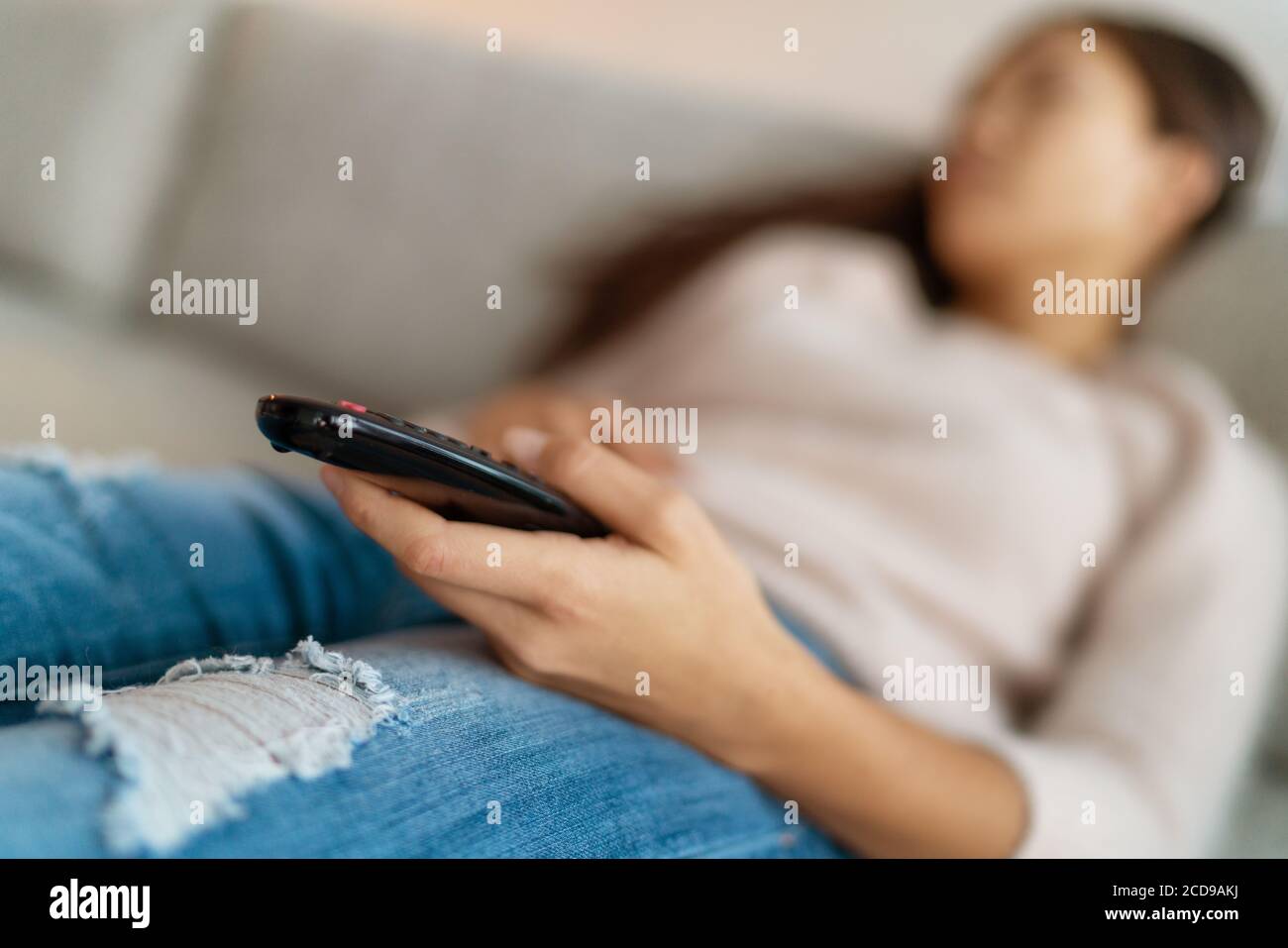 Woman watching tv alone hi-res stock photography and images - Alamy