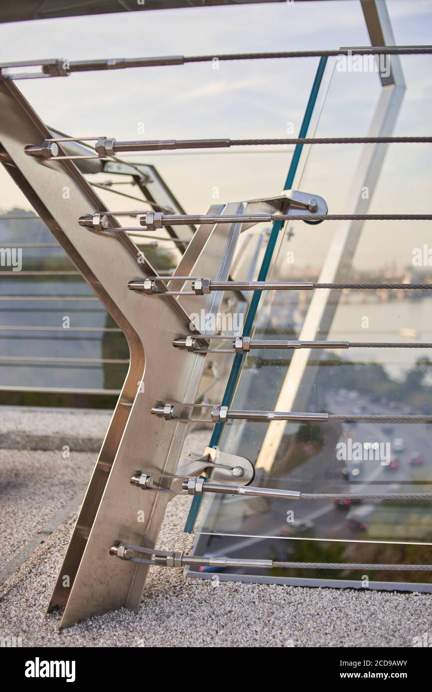A modern bridge over a river fenced by a glass fence Stock Photo - Alamy
