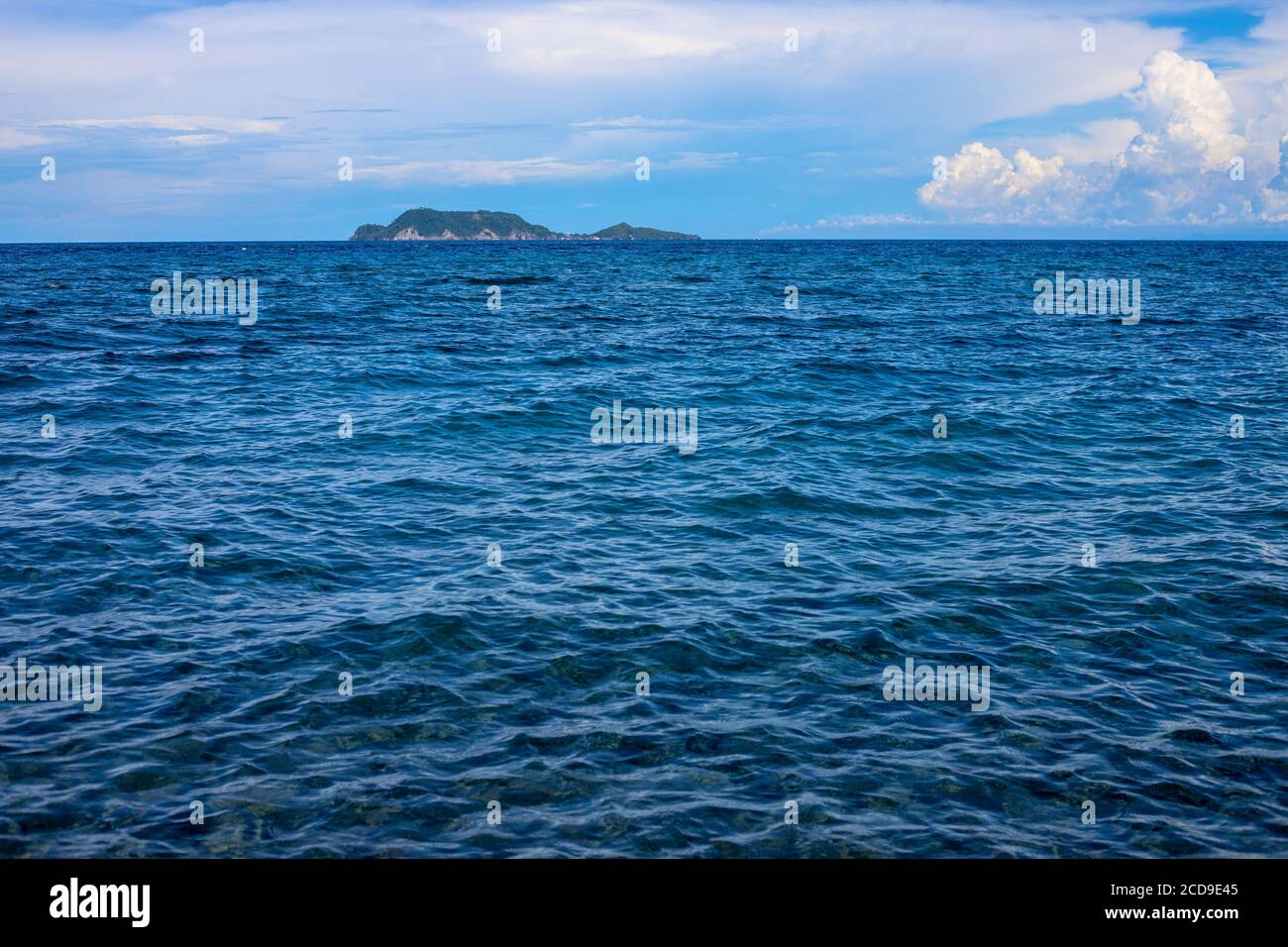 Seaside landscape with water surface and distant island. Sunny sea and ...