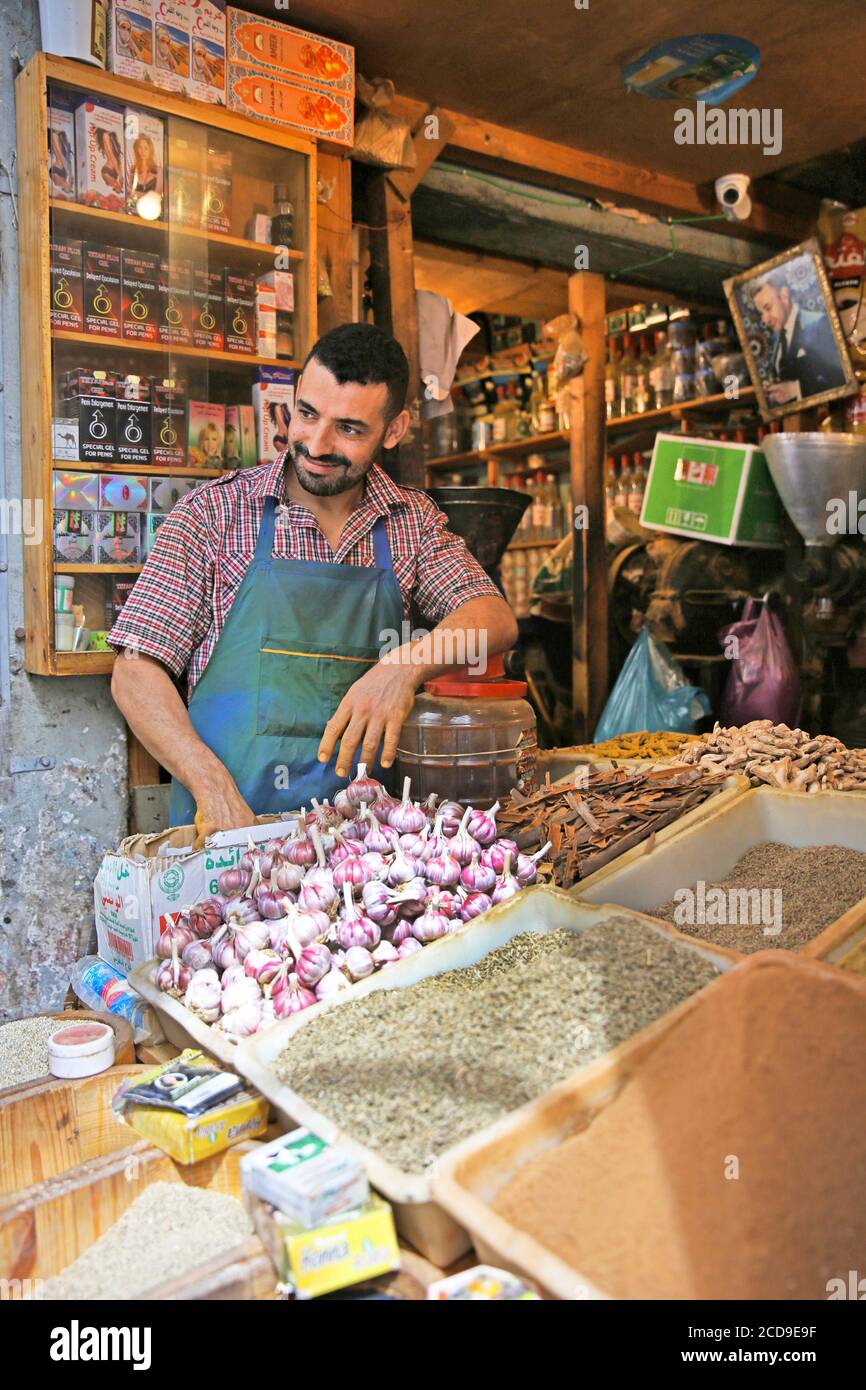 Morocco, Tangier Tetouan region, Tangier, Moroccan merchant in front of ...