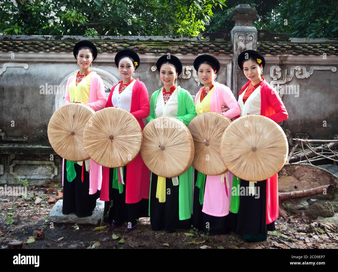 Girls group, dressed in traditional ao dai costumes, singing folk songs ...