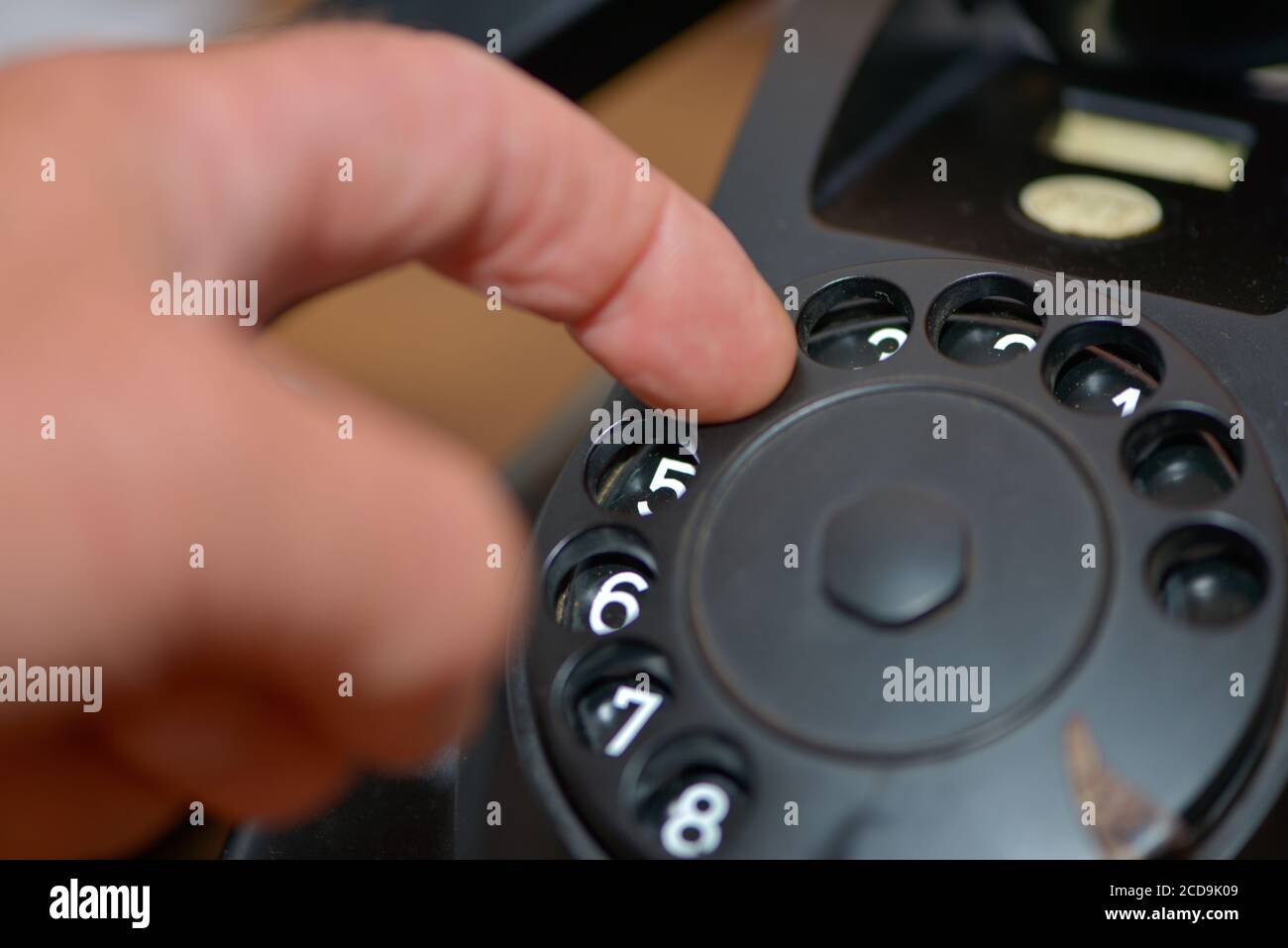 finger dialing an old fashioned bakelite dial phone Stock Photo - Alamy