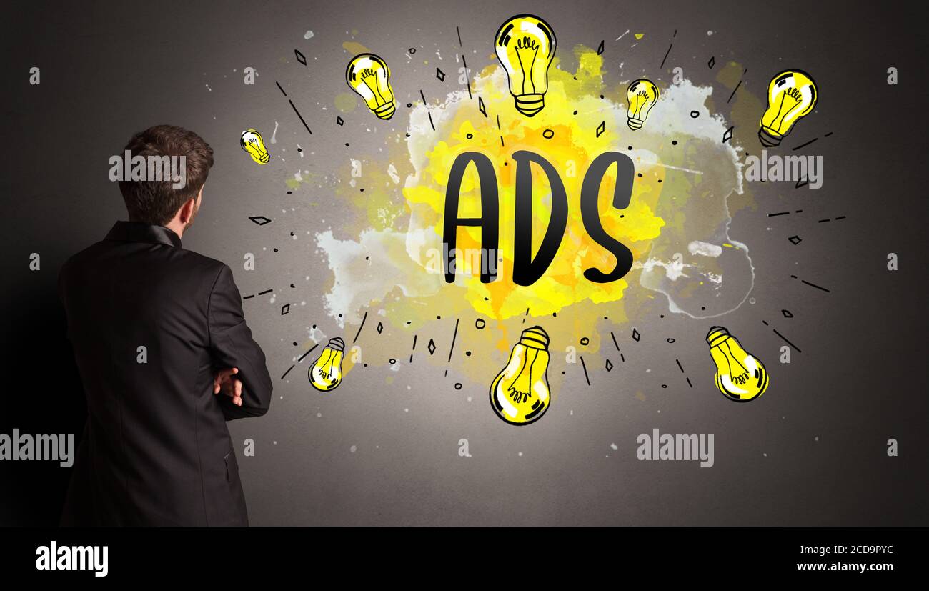 businessman drawing colorful light bulb with ADS abbreviation, new ...