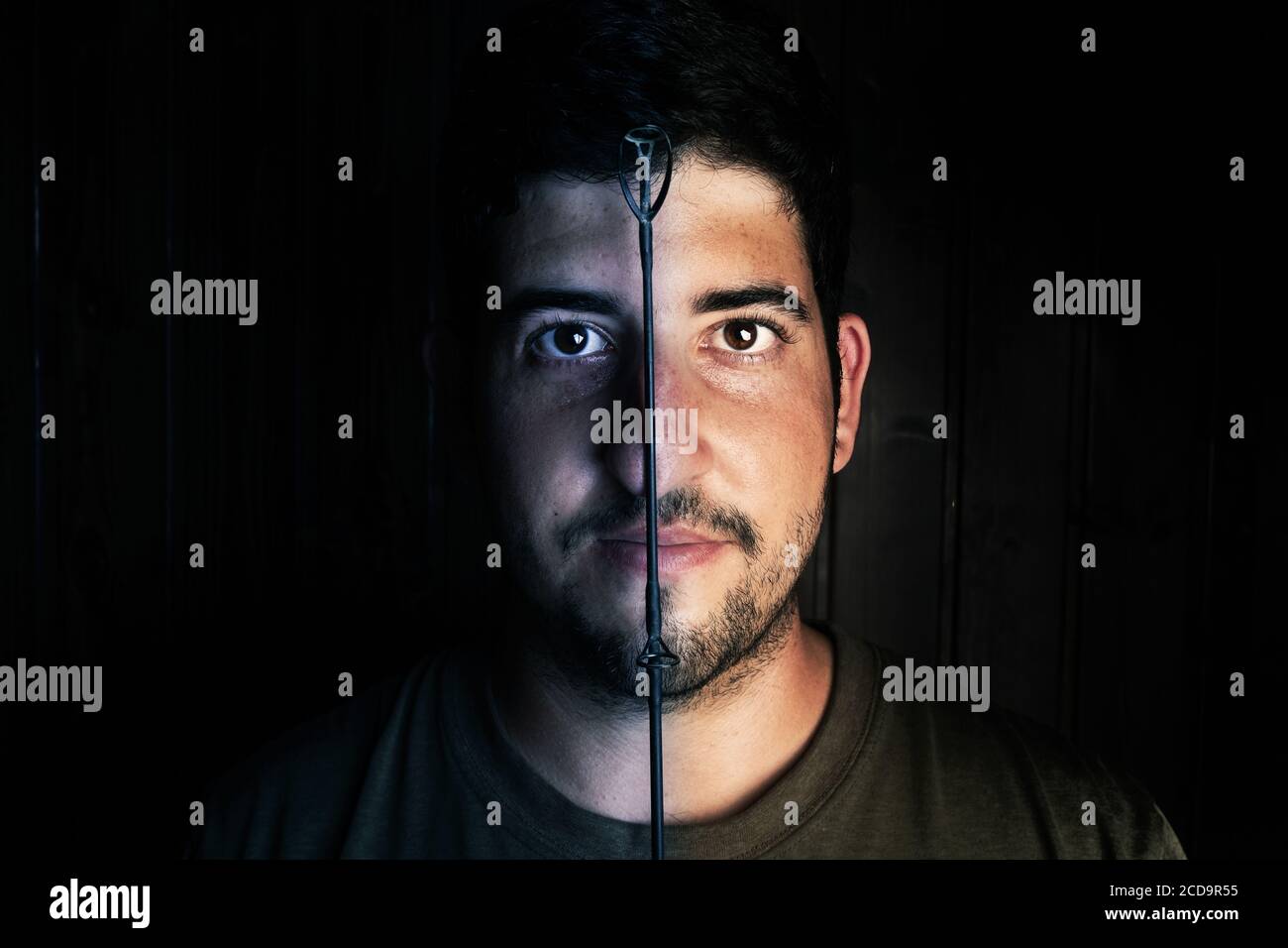 Portrait of a male with a fishing rod splitting his face into two parts ...