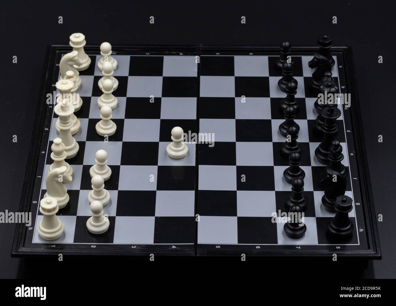 Chess game begin on chessboard. Checked board with figure on black ...