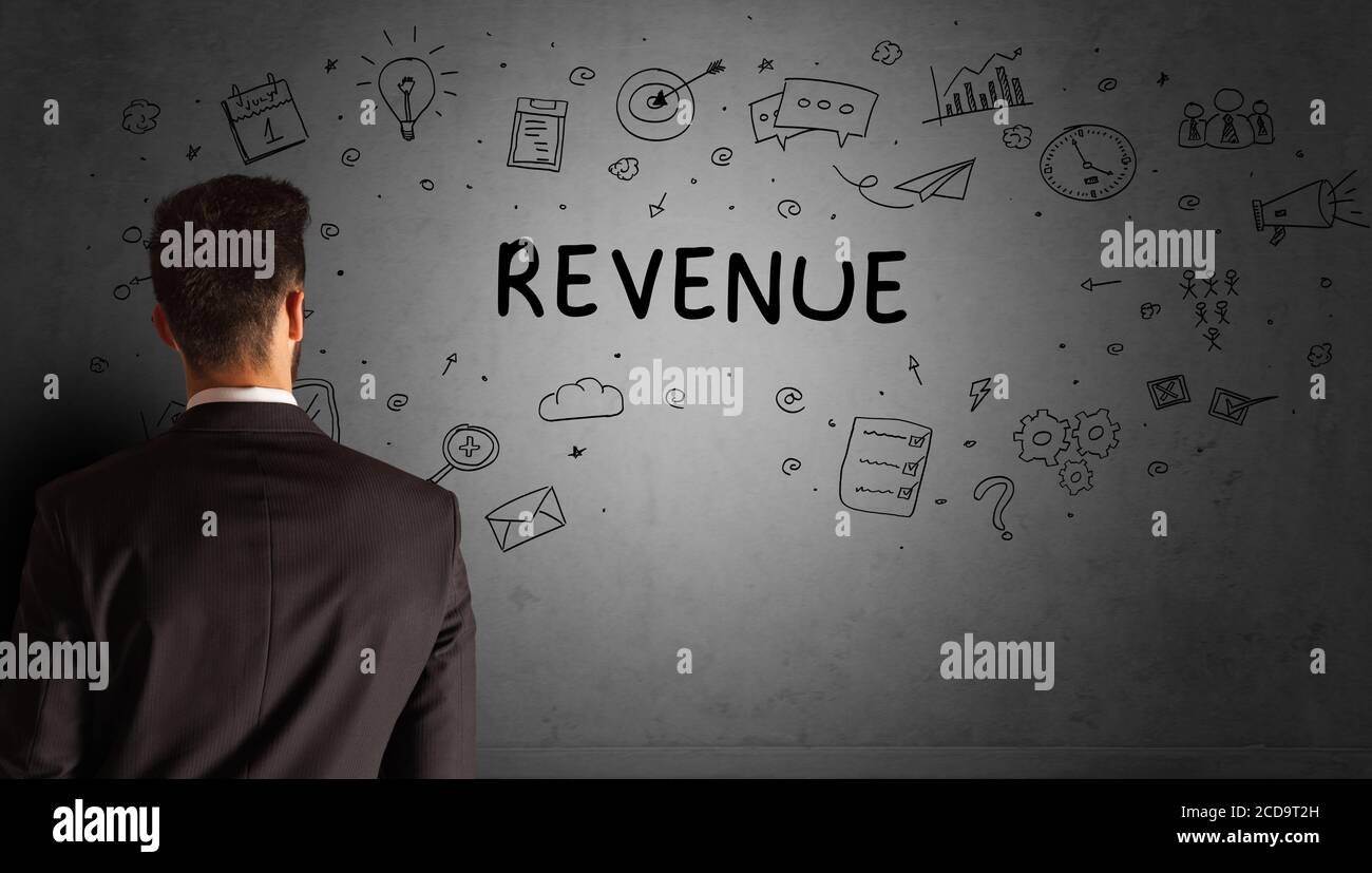 businessman drawing a creative idea sketch with REVENUE inscription ...