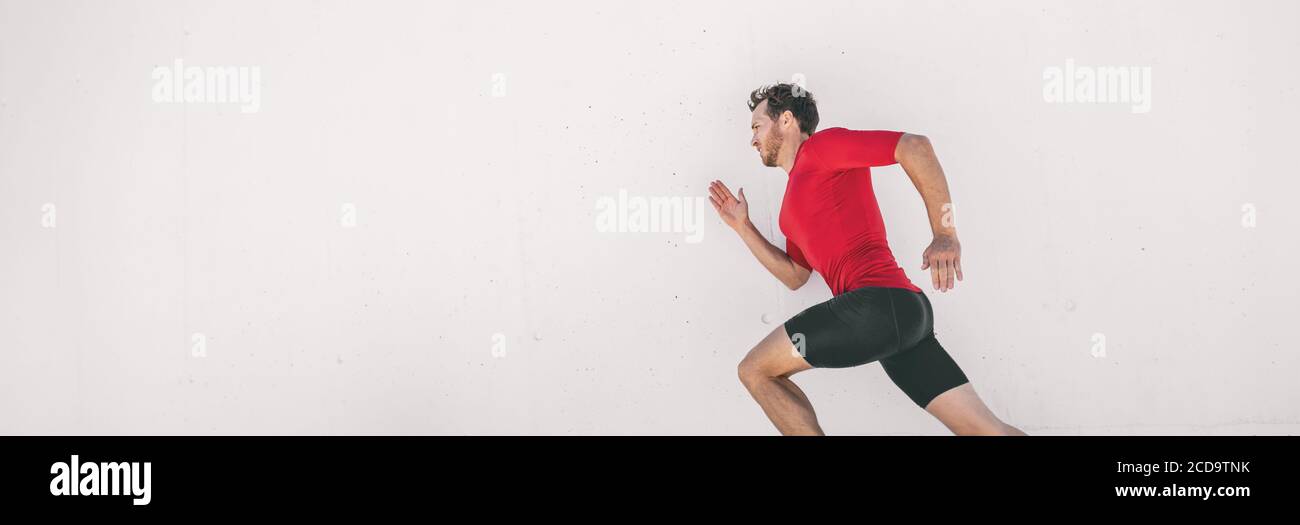 Running man runner training doing city run sprinting along wall outdoor ...