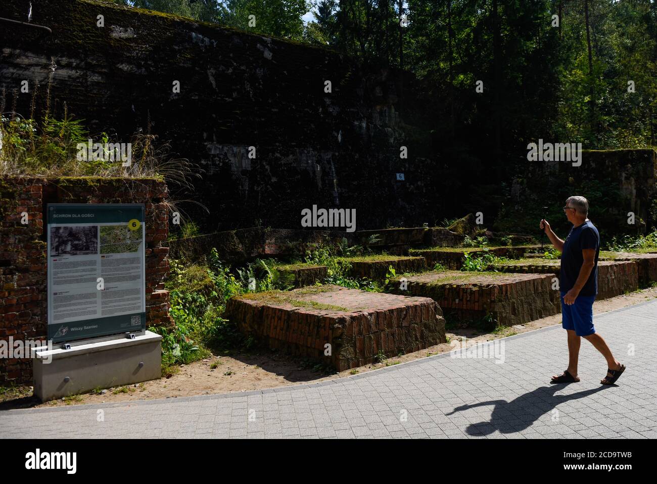 A visitor walks by a destroyed bunker which served as a tea house for ...