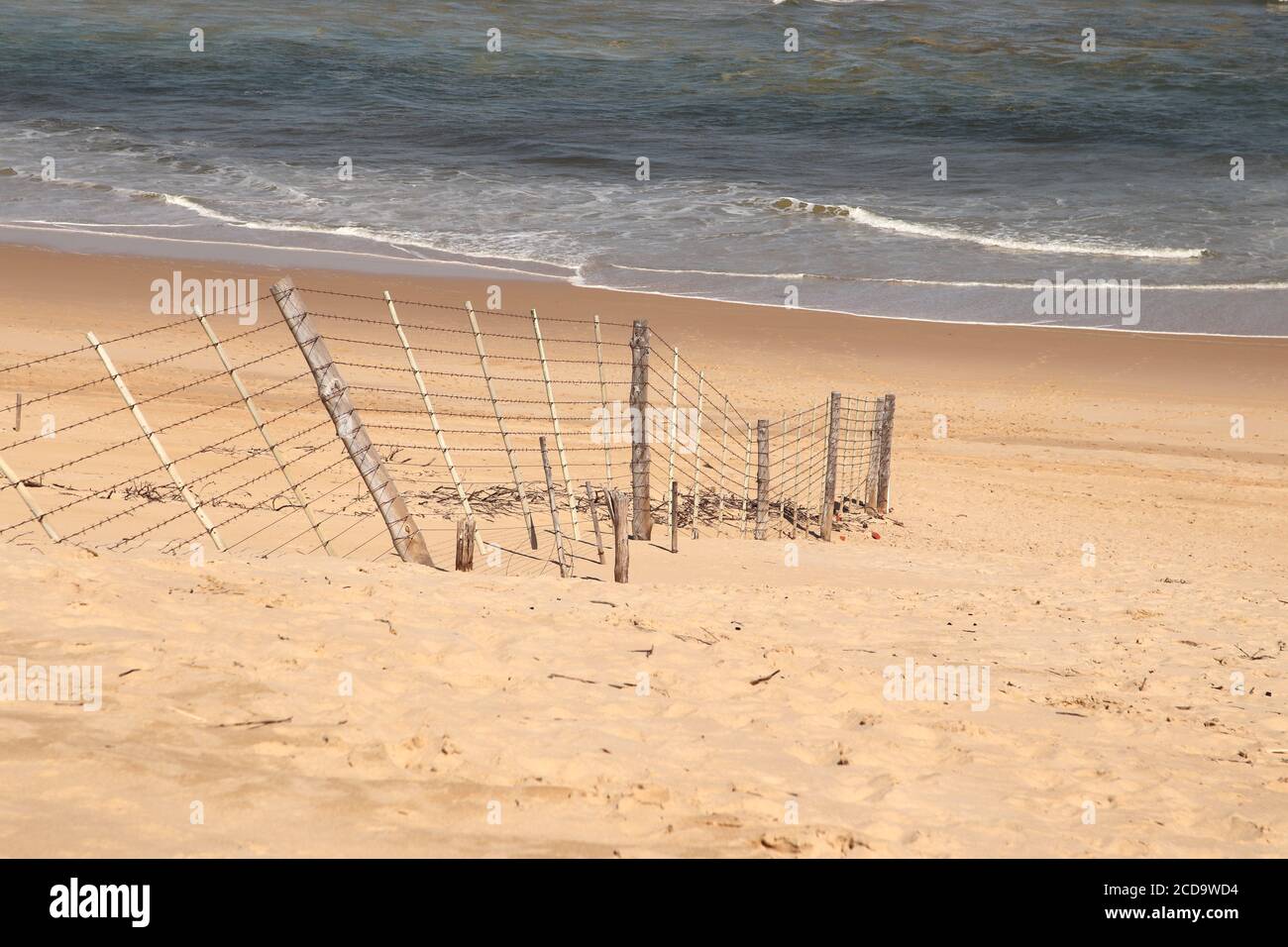 A border fence built on beach sand. Immigration control concept image ...