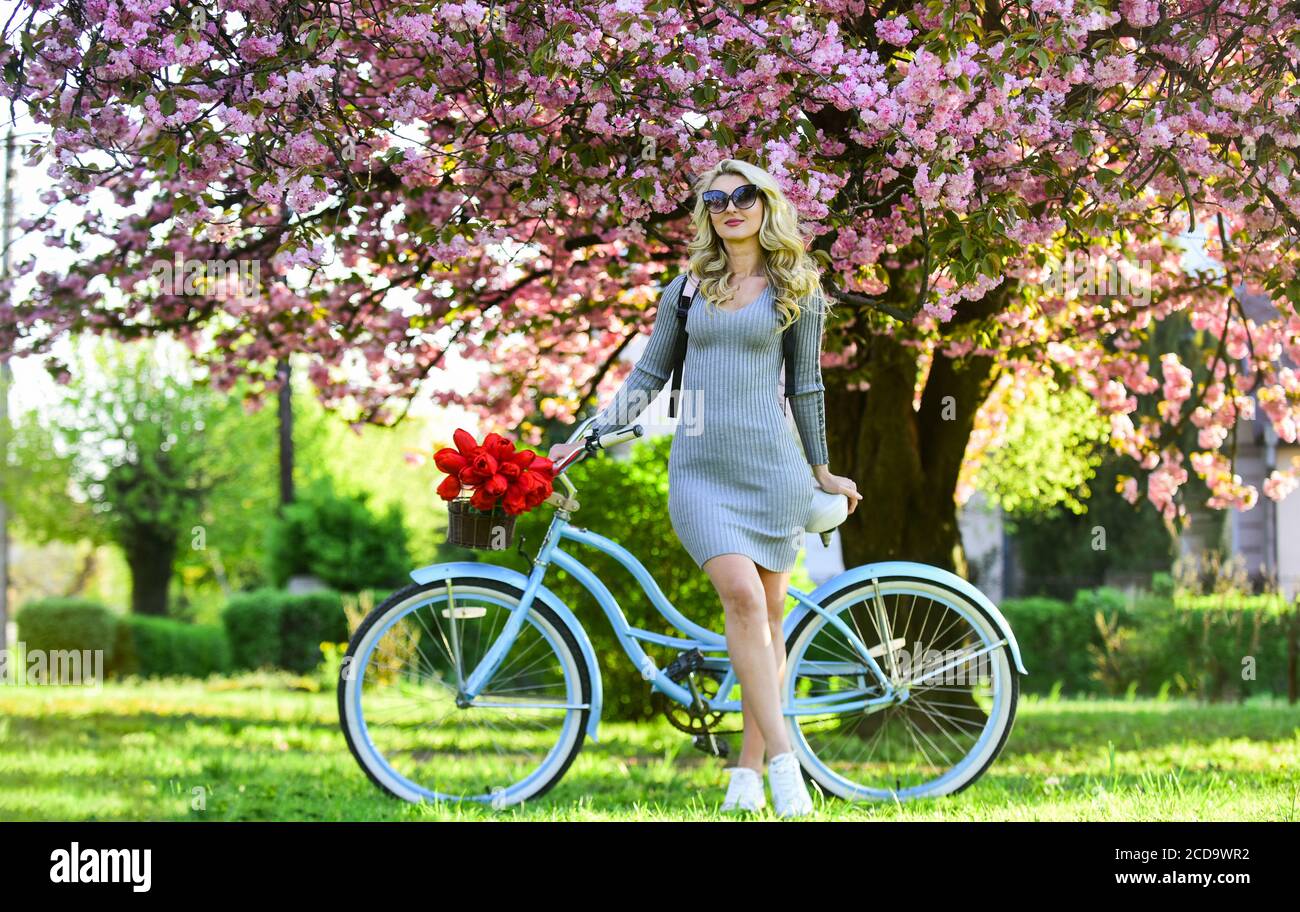 Spring time. girl flower seller with retro bike. vintage bicycle for ...