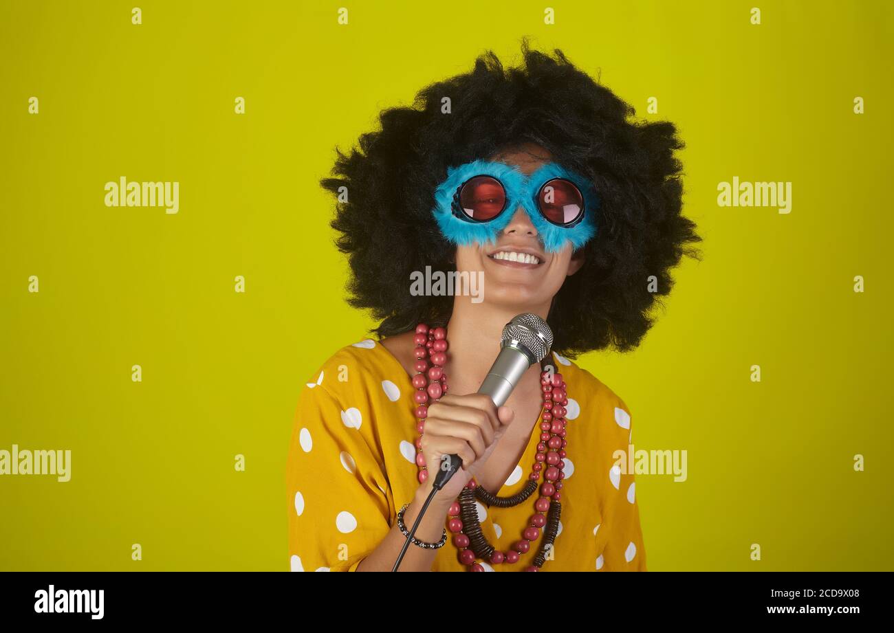 Young beautiful and smiling girl with curly afro hairstyle and funny ...
