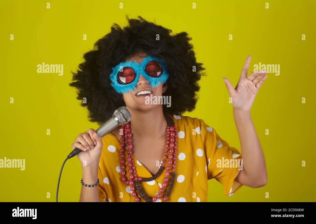 Young beautiful and smiling girl with curly afro hairstyle and funny ...