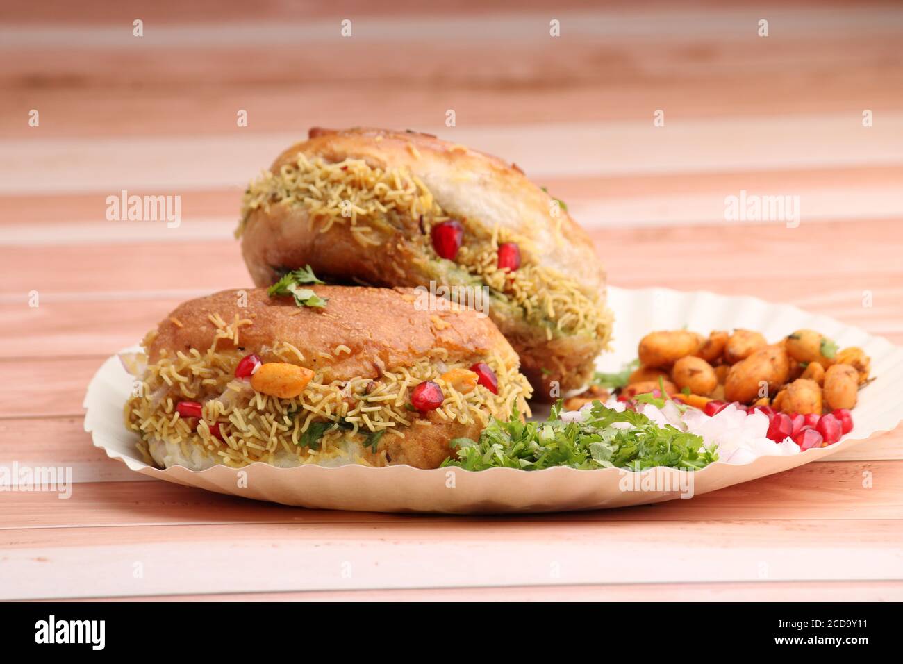 Dabeli is an Indian snack item served with Pomegranate Seeds and ...