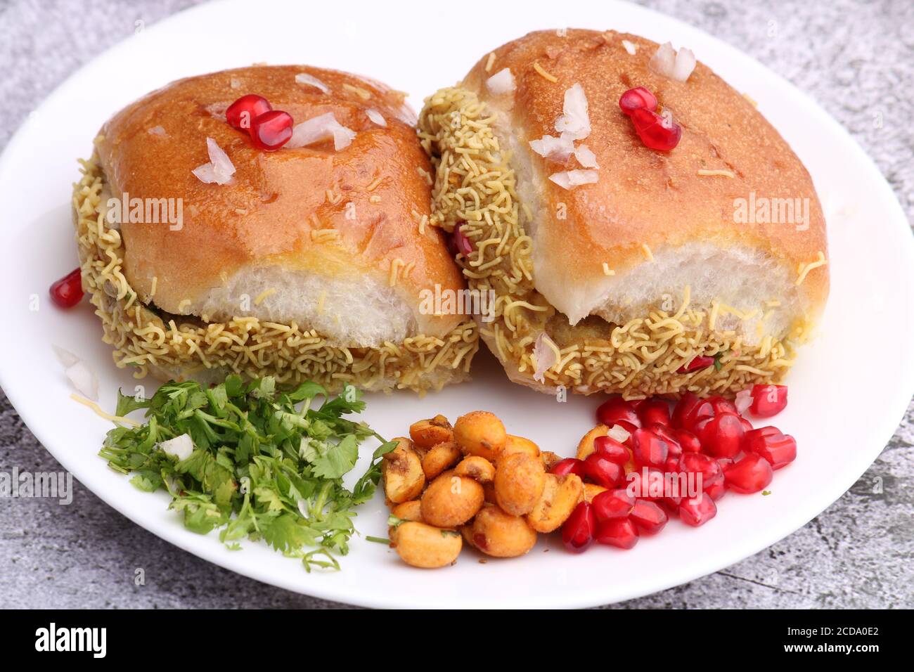 Dabeli is an Indian snack item served with Pomegranate Seeds and ...