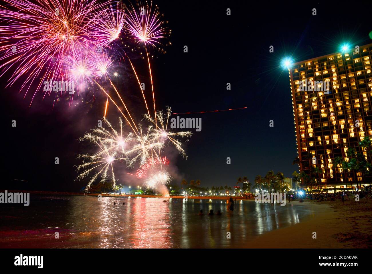 Weekly firework display over touristy beach and waterfront, in front of ...