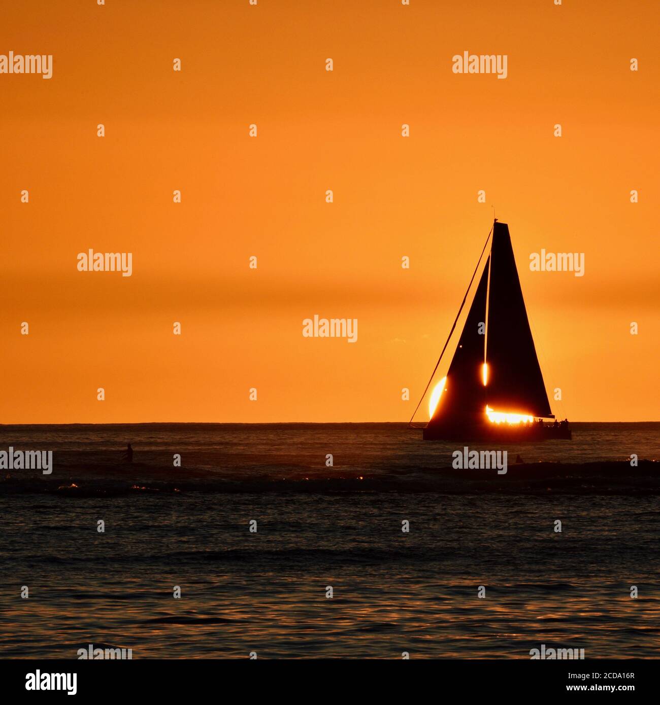 Spectacular and colorful golden sunset with silhouetted sailboat and ...