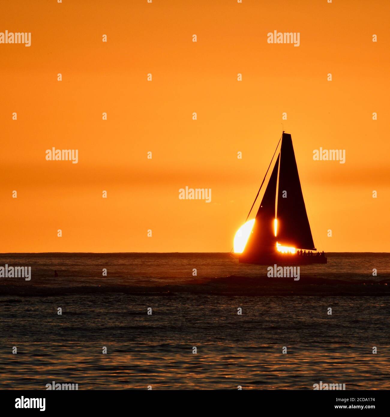 Spectacular and colorful golden sunset with silhouetted sailboat and ...