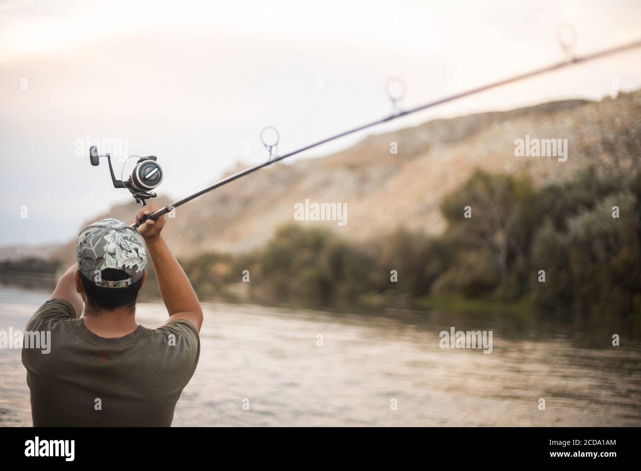 Back view of a male fishing in the river Stock Photo - Alamy